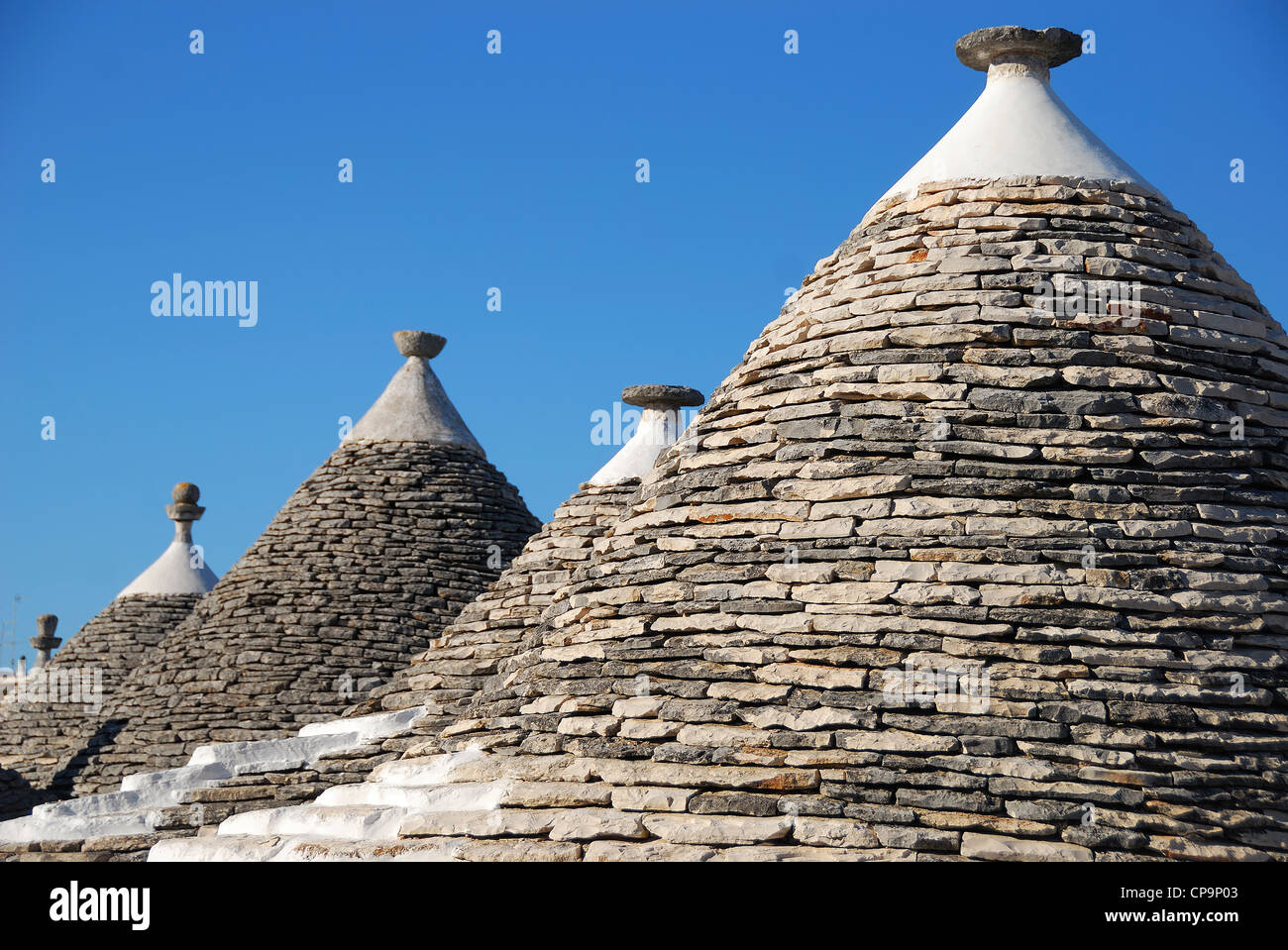 The conical rooves of trulli, traditional Apulian dry stone huts in ...