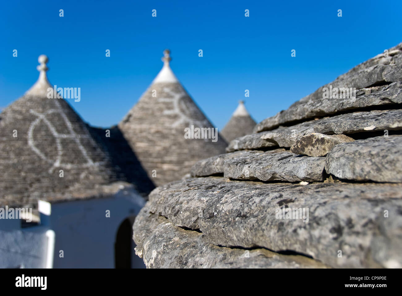 The conical rooves of trulli, traditional Apulian dry stone huts in ...