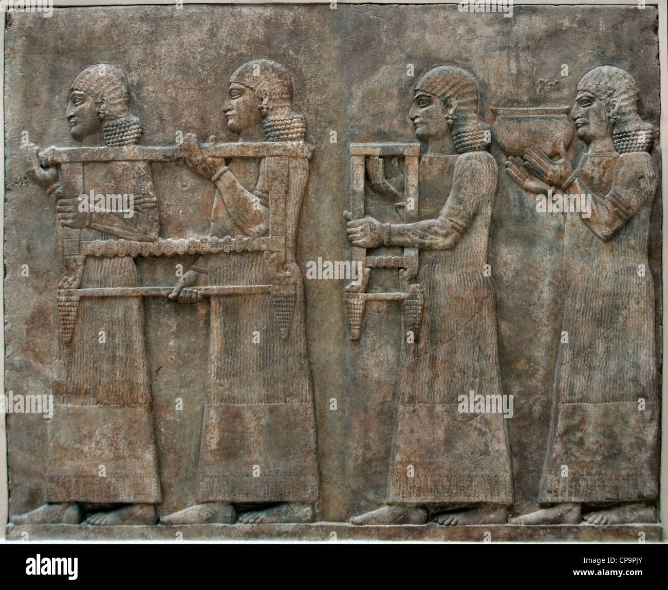 Two servants carrying a chair and a vase Neo Assyrian Sargon II 721-705 ...