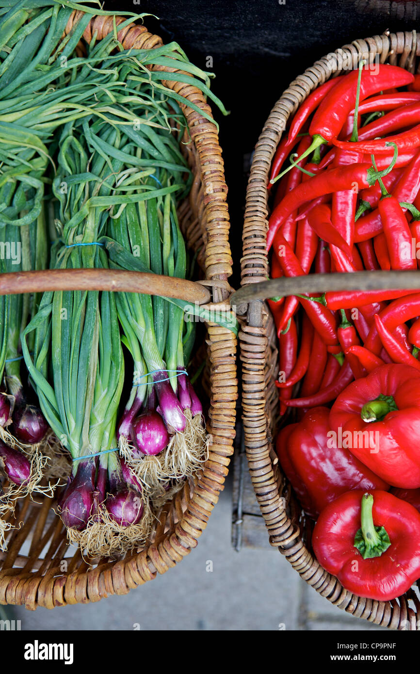 Spring onions red peppers and chilies in baskets, Arundel, Sussex ...
