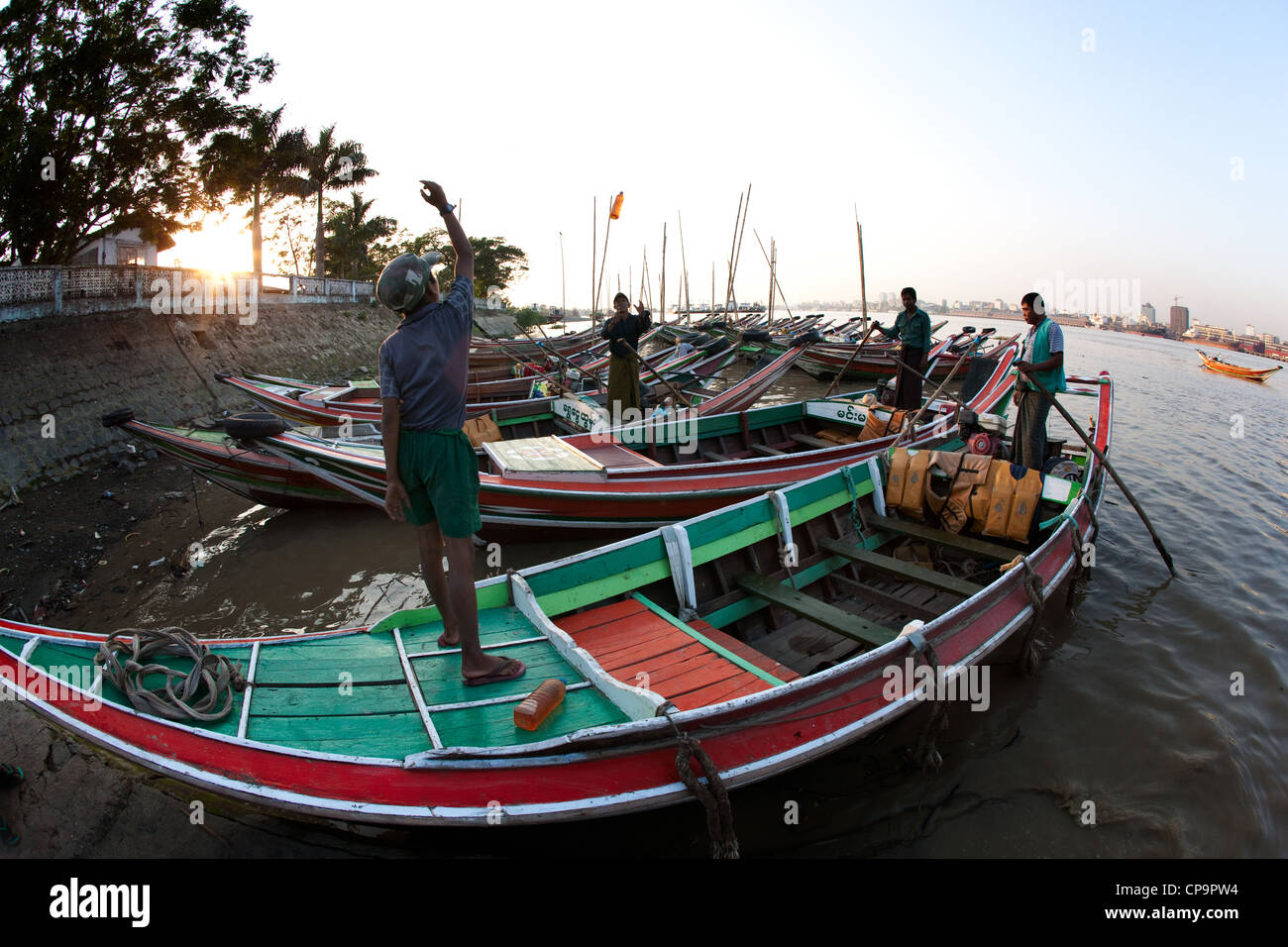 Young man throwing fuel containers standing on a fish boat in Dallah ...