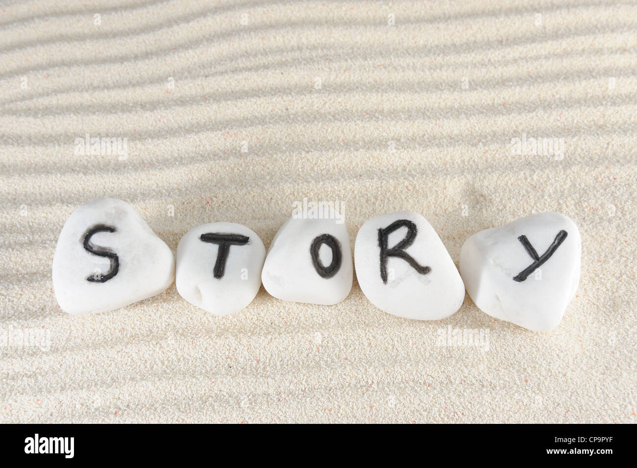 Story word carved on stones of the beach Stock Photo - Alamy