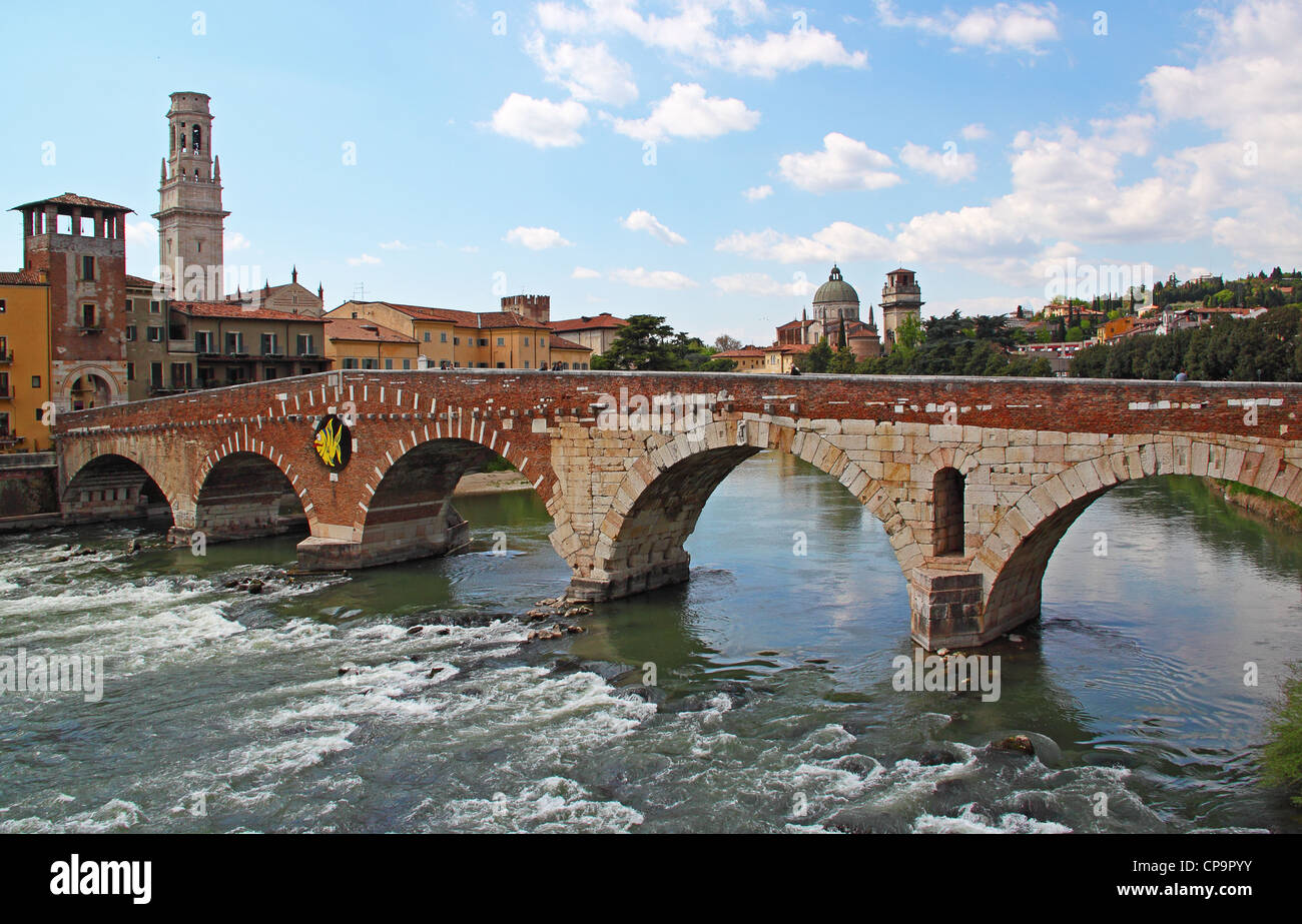 The old bridge in Verona, Italy. On the background the high tower of ...