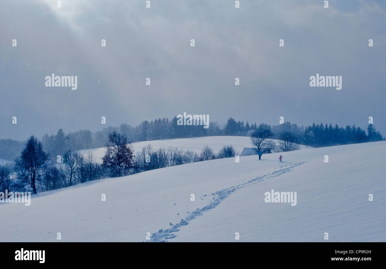 An idyllic winter scene of sunlight shining on people walking home ...