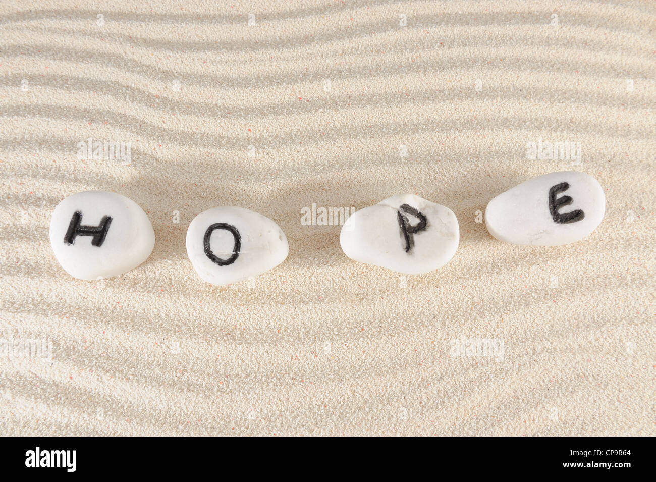 Hope word on group of stones with sand as background Stock Photo - Alamy