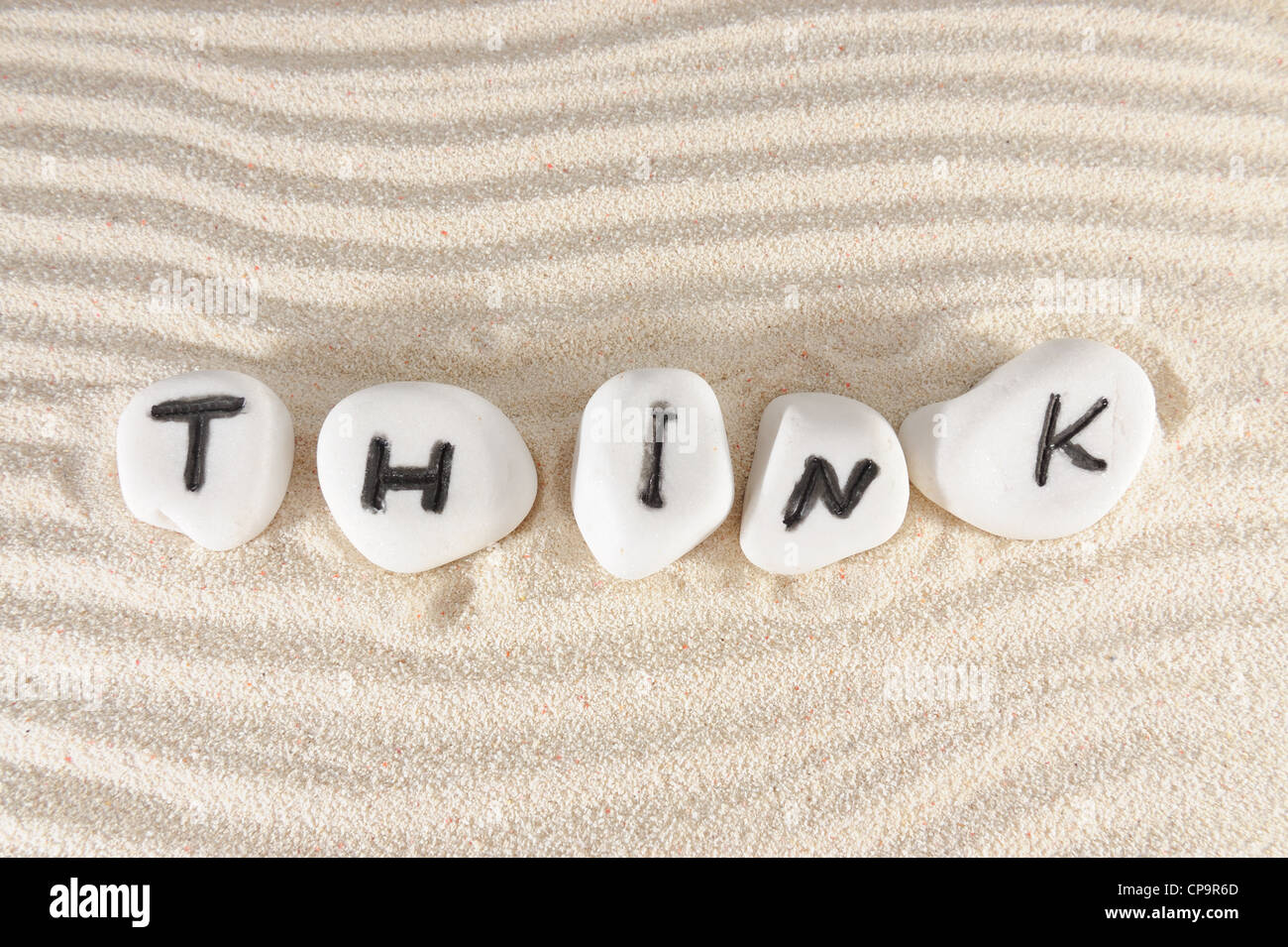 Think word on group of stones with sand as background Stock Photo - Alamy