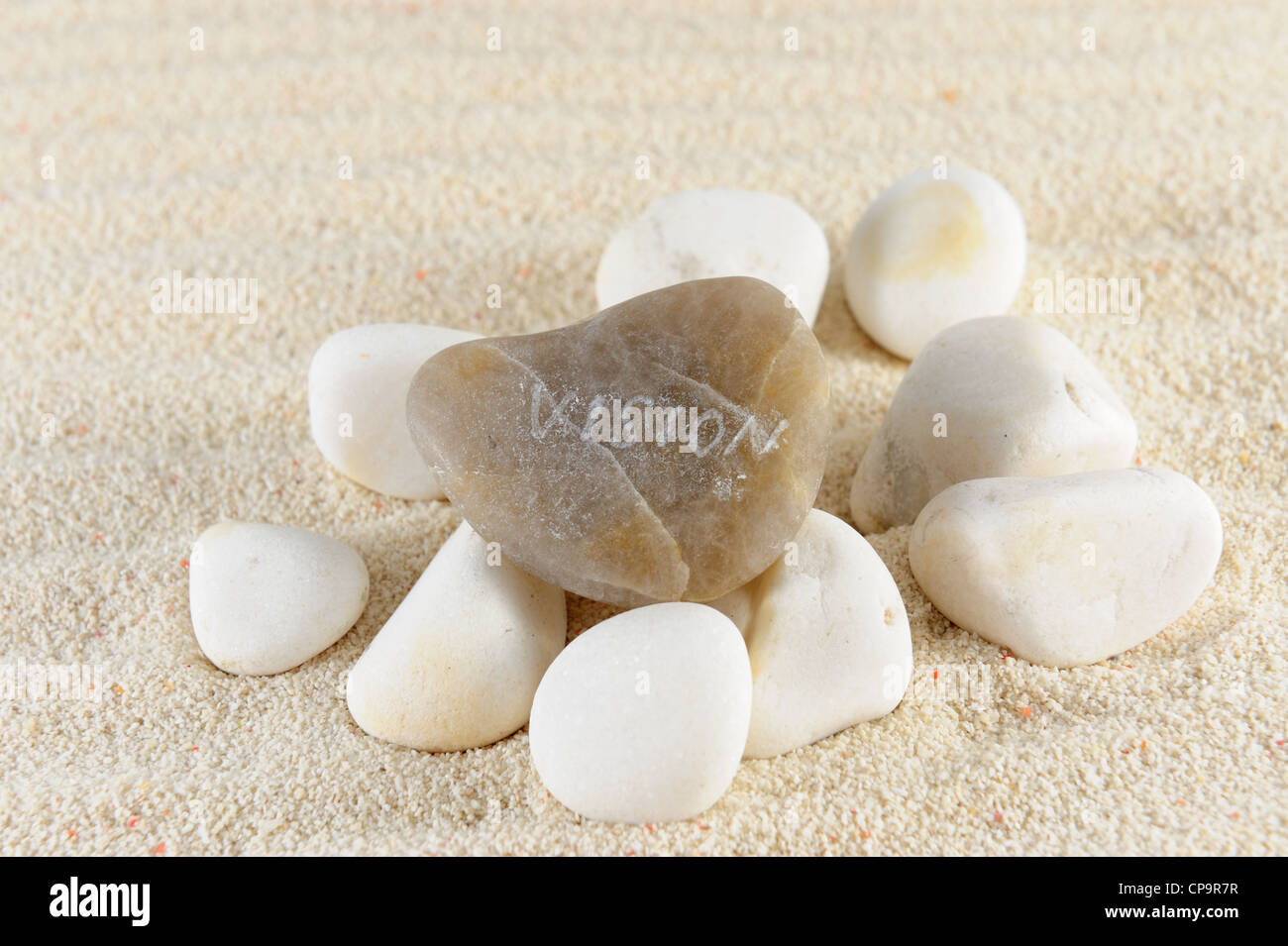Vision word carved on stone with sand and stones background Stock Photo ...