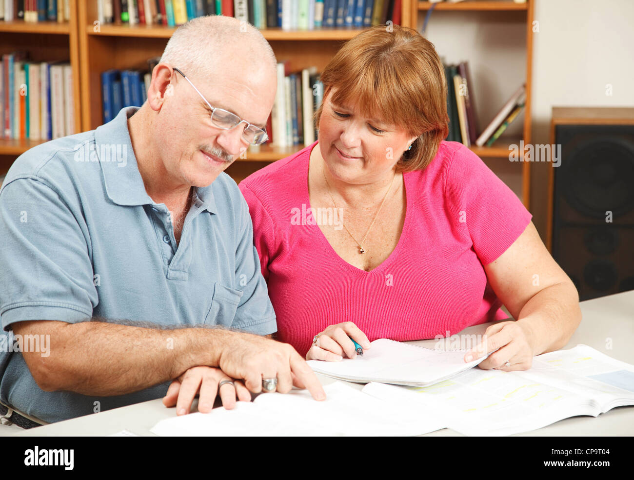 Adult students studying together in the library Stock Photo - Alamy