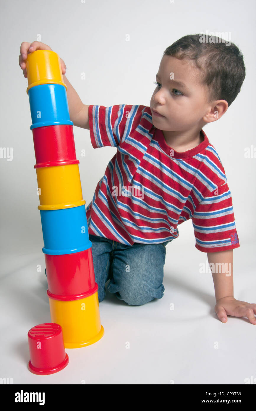little boy building colourful stack tower Stock Photo - Alamy