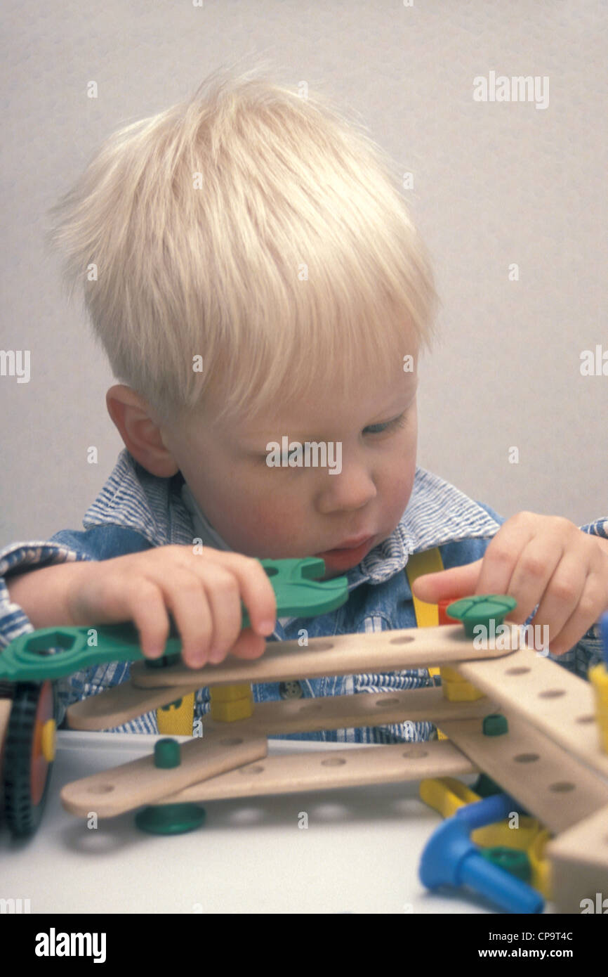 toddler building with wooden mechano Stock Photo - Alamy