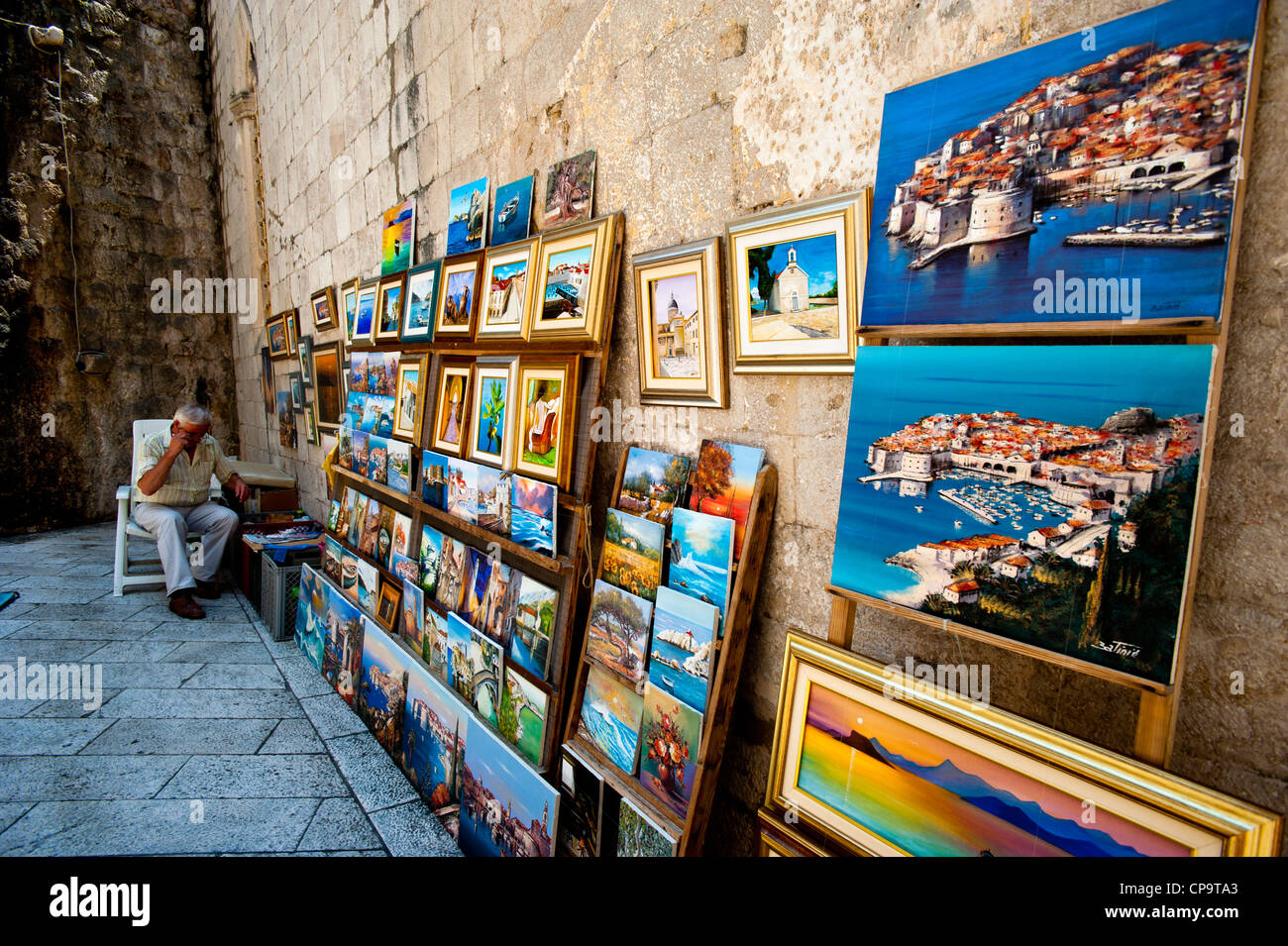 Artist selling paints at street stall old town. Dubrovnik. Dubrovnik ...