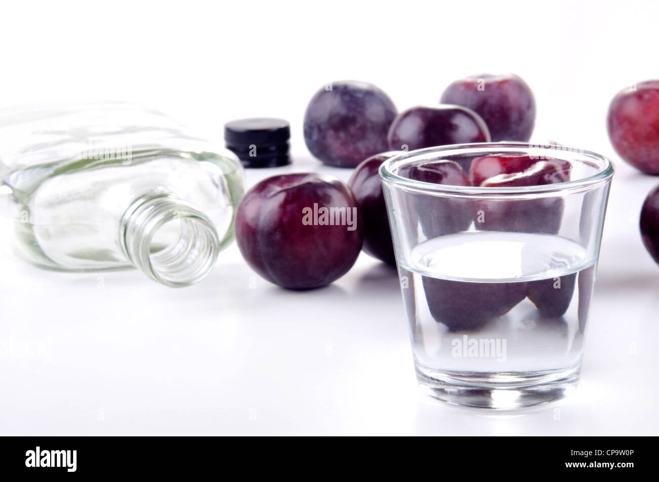 plum brandy in a small glass and fresh plums Stock Photo - Alamy