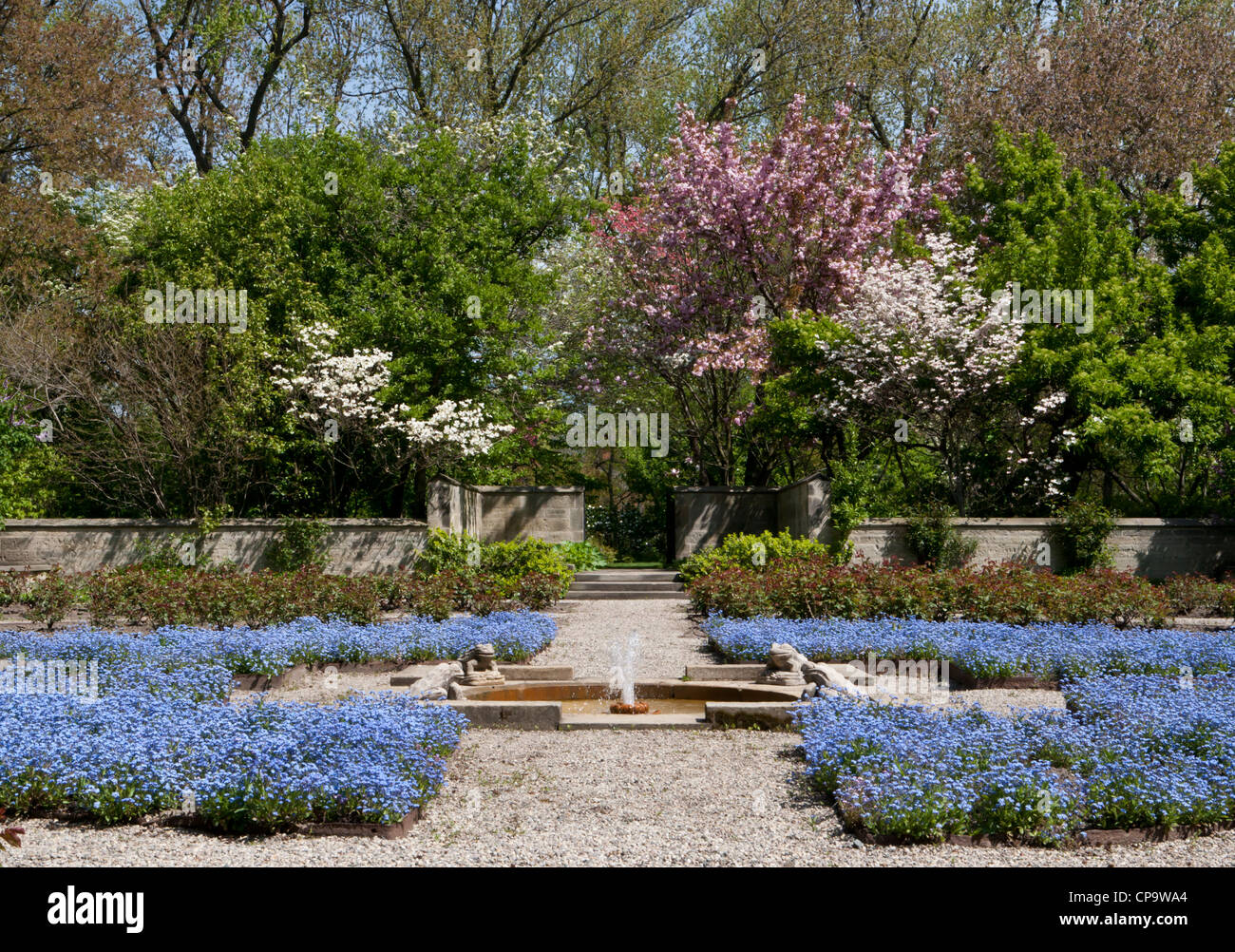 Beautiful flowers are seen on the trees that are blooming in the formal ...