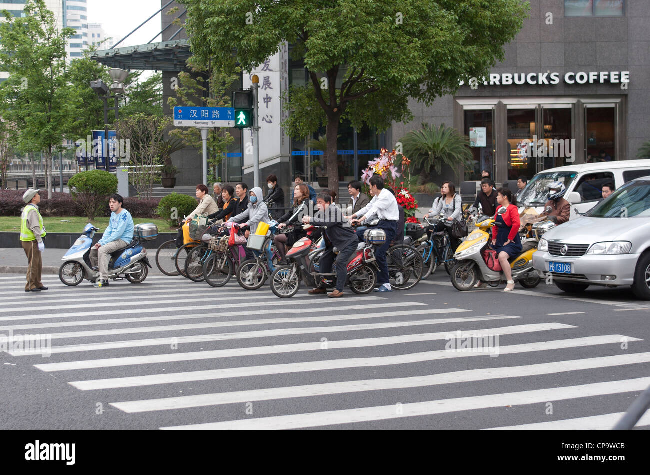 A traffic assistant holding up traffic, Hangyan Lu, Shanghai, China ...