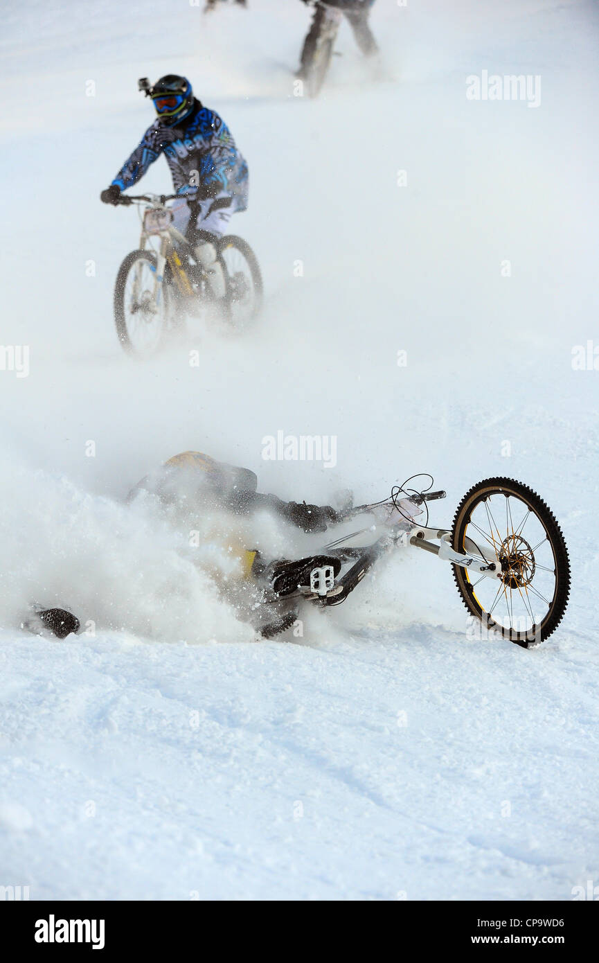 A mountain biker crashes while racing on snow during the Saas Fee ...