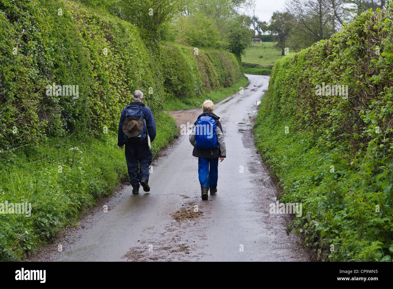 Woman walking down country lane hi-res stock photography and images - Alamy