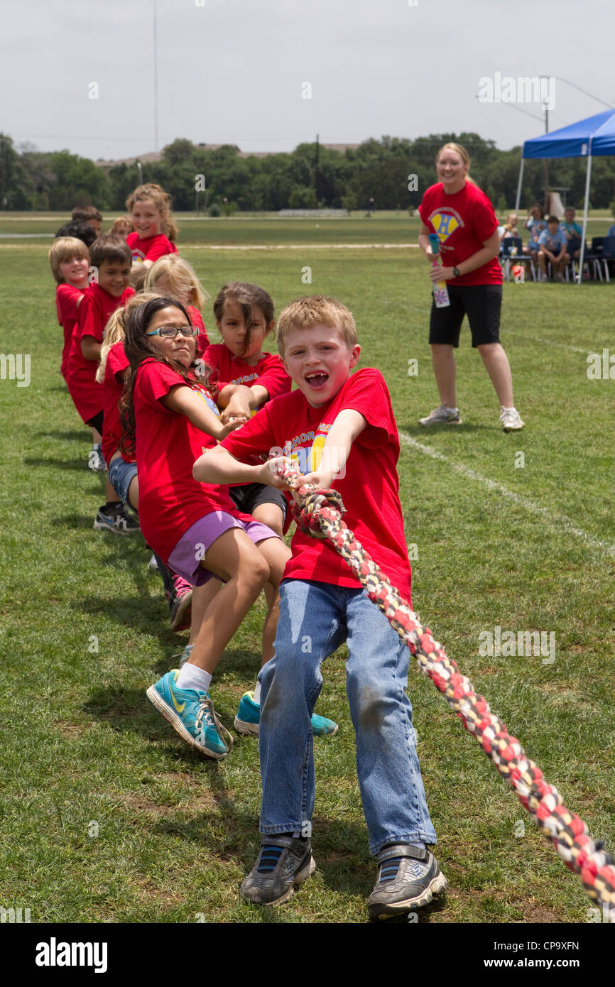 Second grade elementary school age kids participate in tug-of-war ...