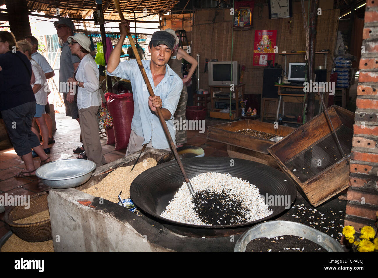 Vietnamese man making rice popcorn, Cuu Long, Cai Be, Mekong Delta ...