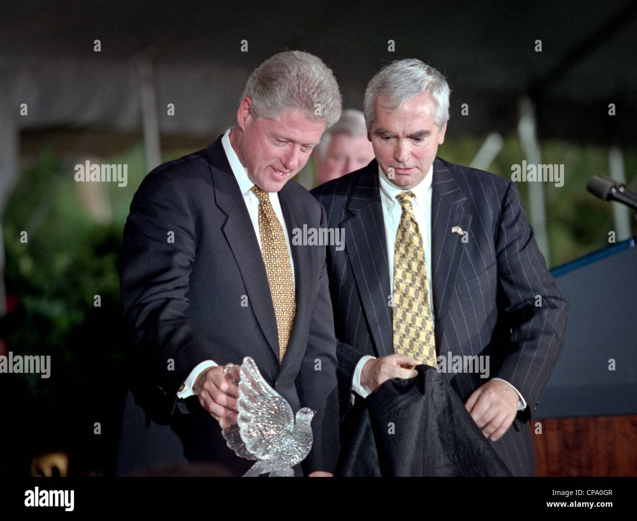 US President Bill Clinton admires an award given to him by Brian O ...