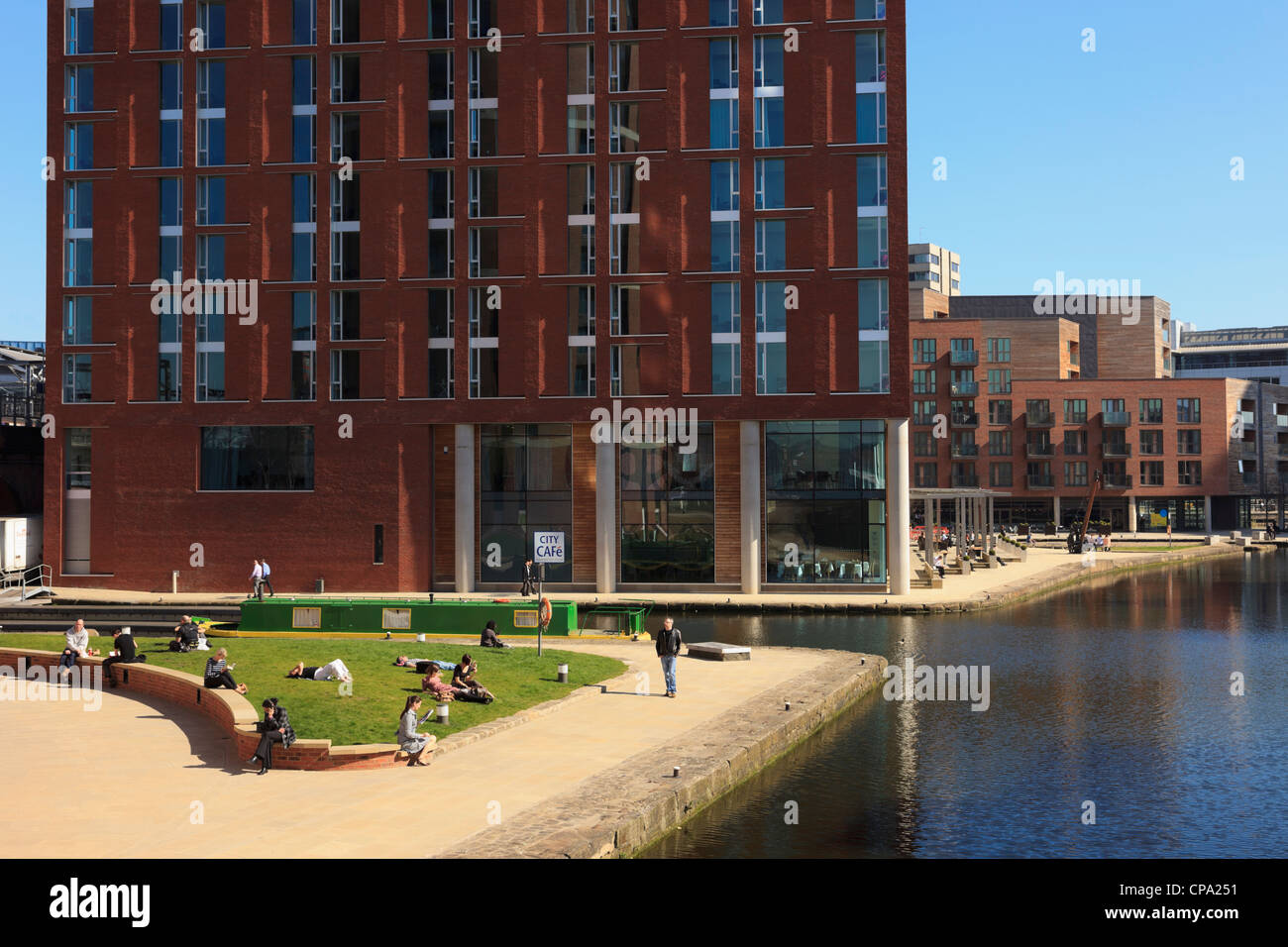 Canalside scene by modern buildings in Waterfront district on Leeds and ...