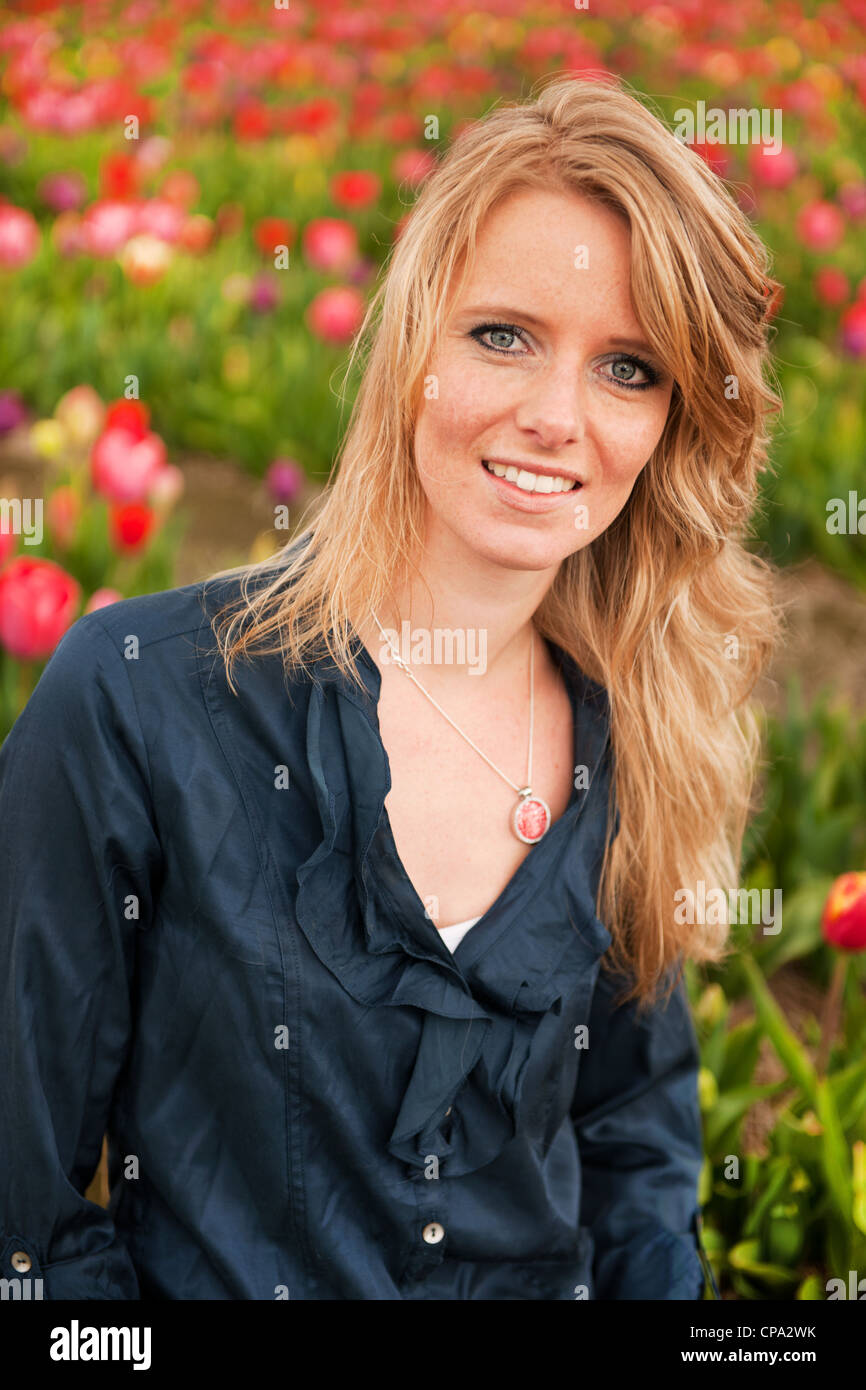 Portrait of a beautiful blond Dutch girl in tulips field Stock Photo ...