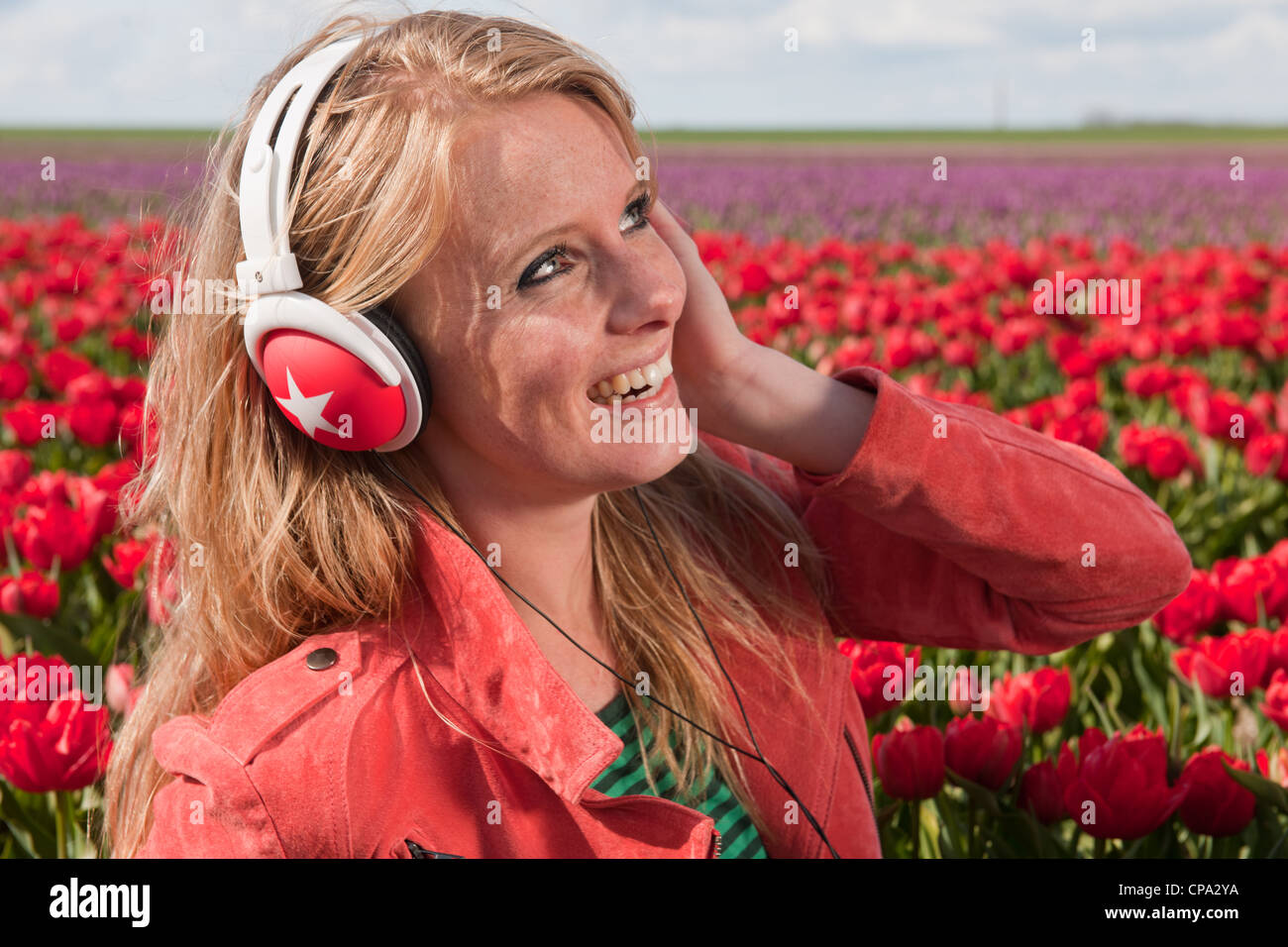 Dutch girl with long blond hair is listening to music Stock Photo - Alamy