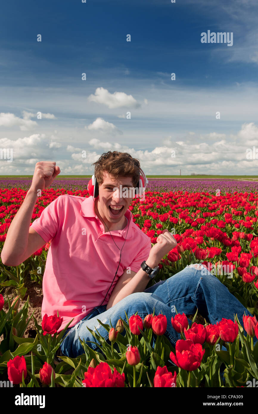 Dutch man sitting in flower fields listeing to cool music Stock Photo ...