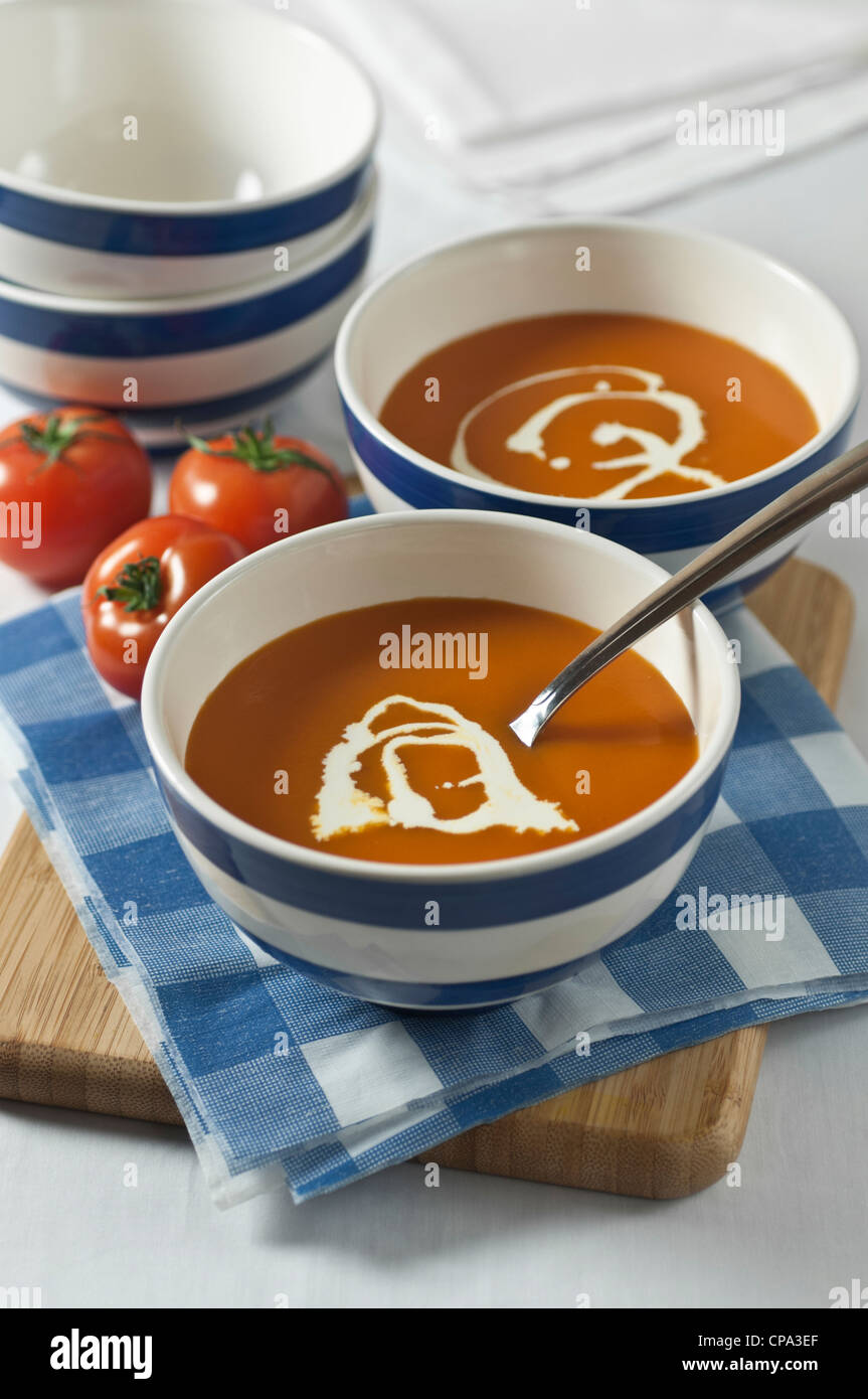 Tomato soup in blue and white striped bowls Stock Photo - Alamy