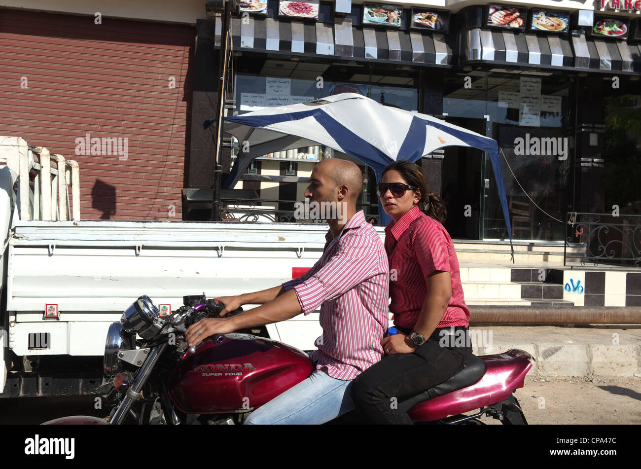 Men and woman on motorcycle in street. Hurghada, Egypt, Africa Stock ...