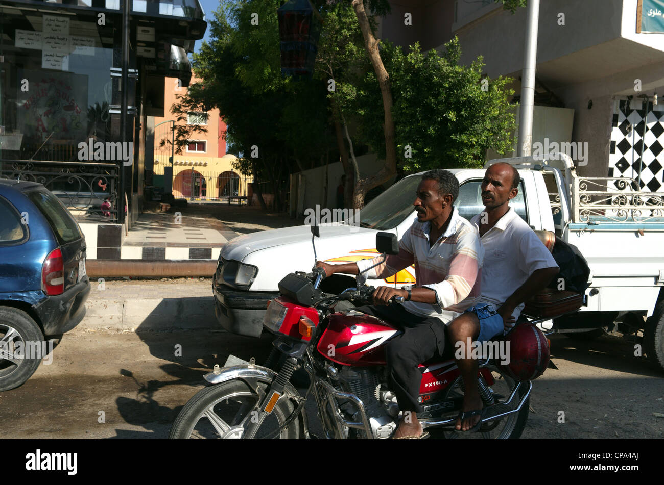 Two men on motorcycle in street. Hurghada, Egypt, Africa Stock Photo ...