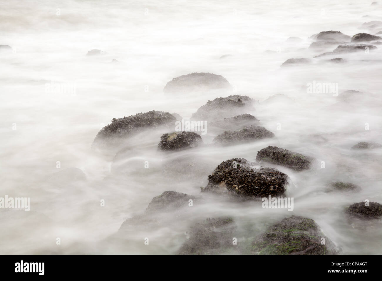 stones in sea waves at long exposure Stock Photo - Alamy
