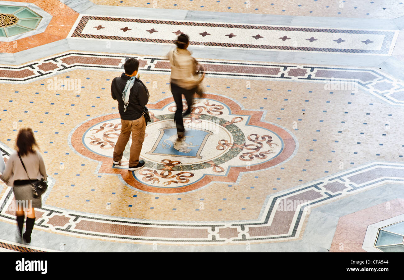 Elevated view of a tourist spinning on the mosaic bull's testicles in ...