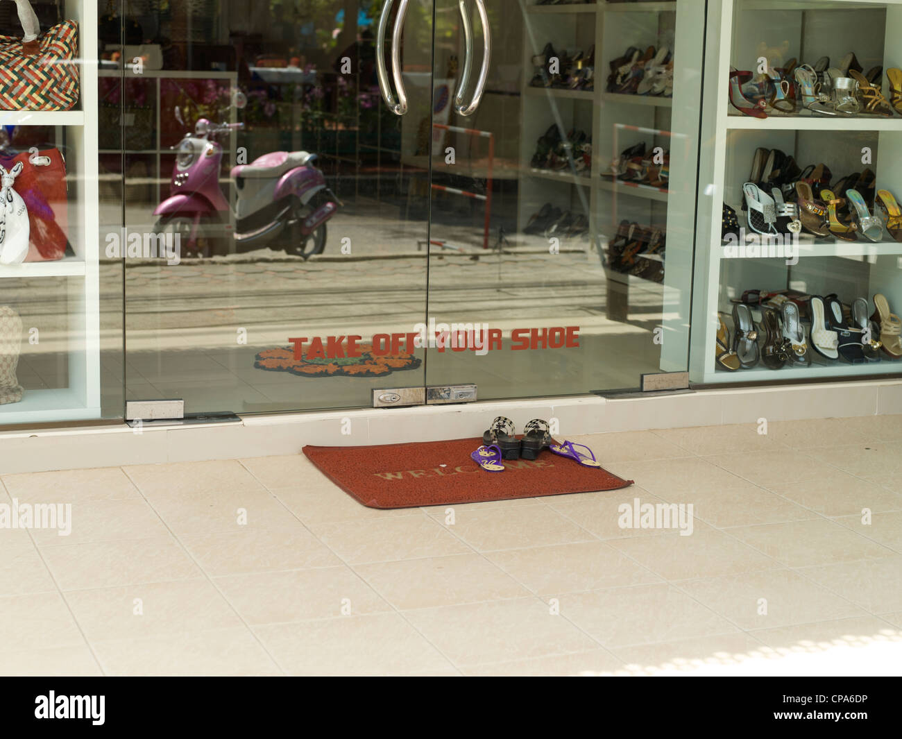 Shoe shop with take off shoes sign Stock Photo - Alamy