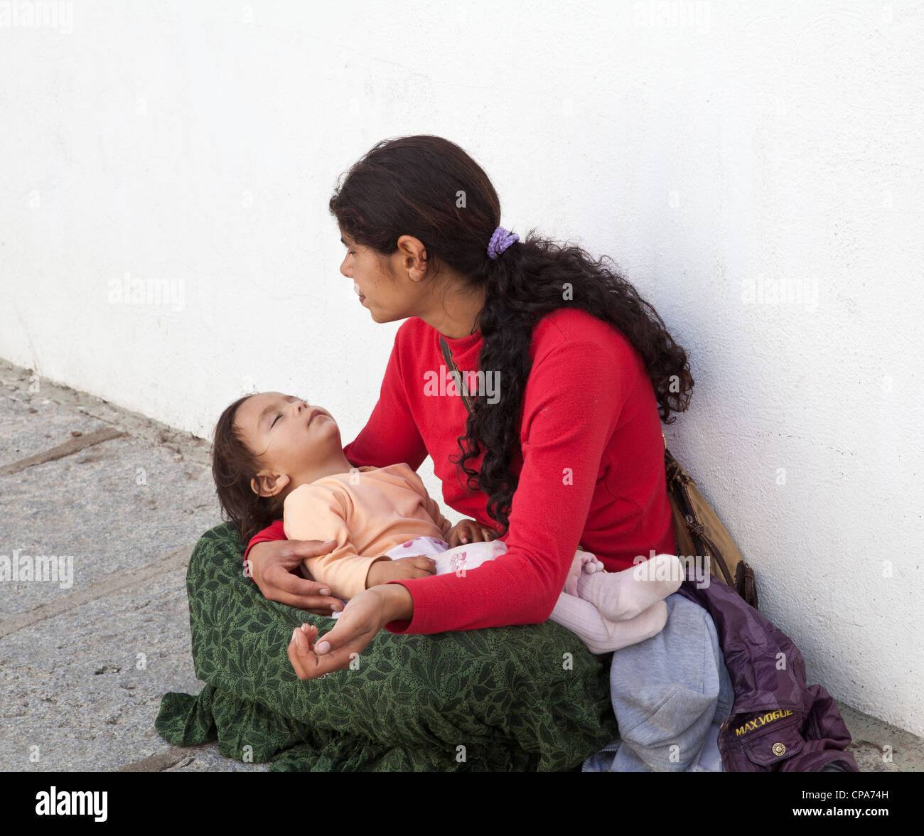 Mother begging with child Stock Photo - Alamy