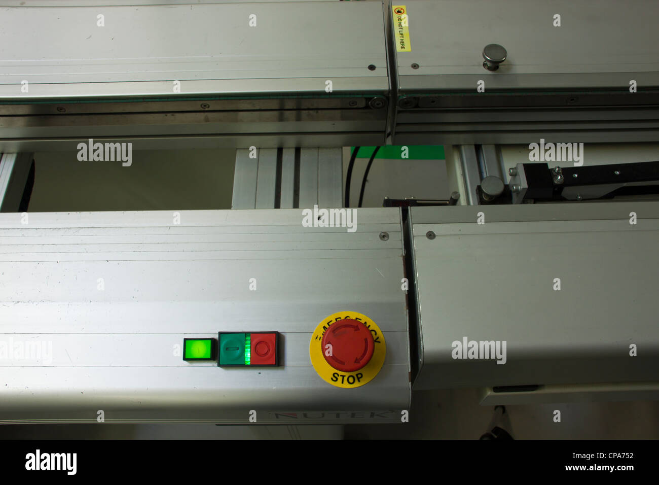 stop, go and emergency stop button used on conveyor belt section within ...