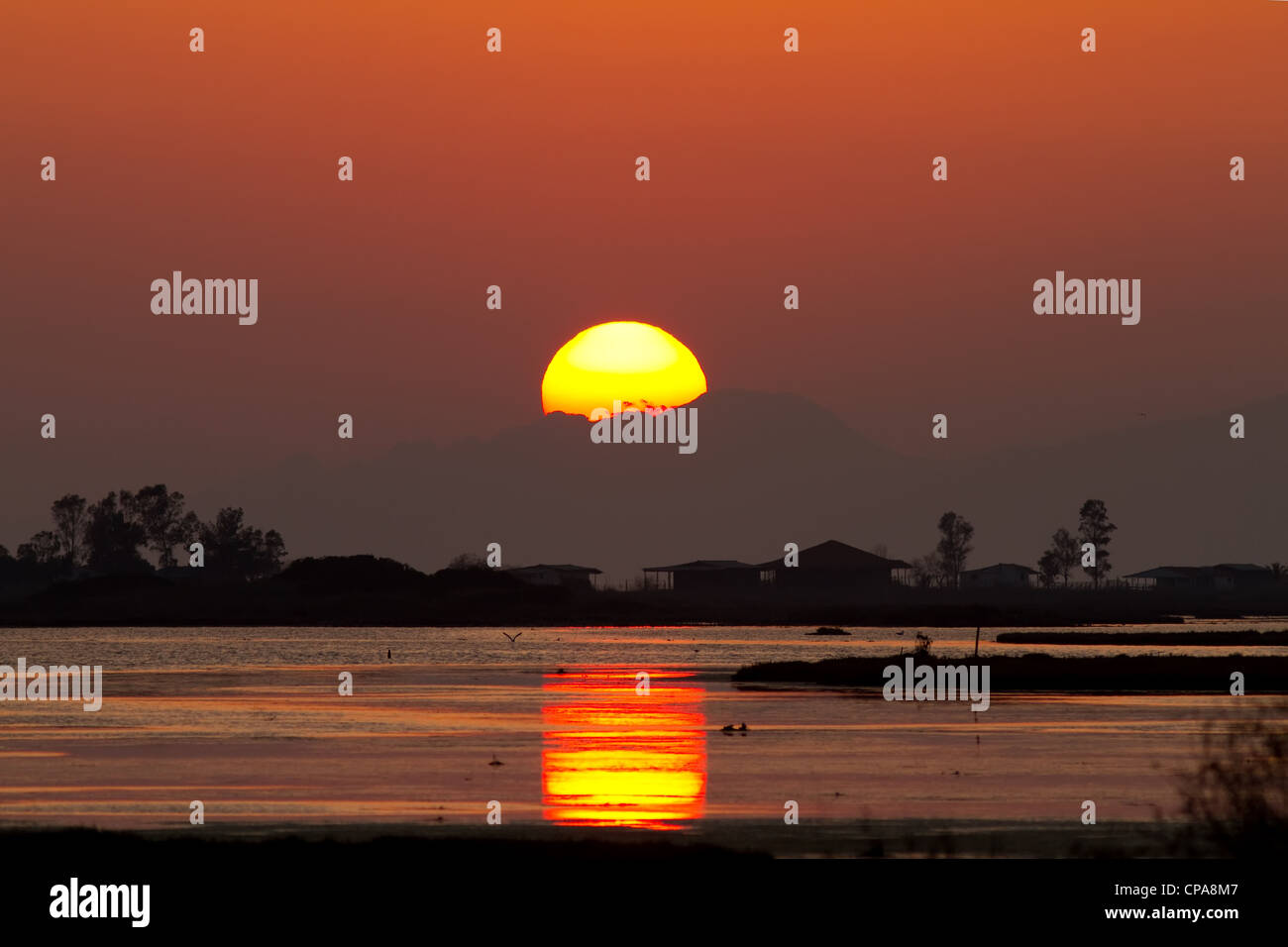 A magnificent sunset over the lagoon of Mesologgi, western Greece Stock ...