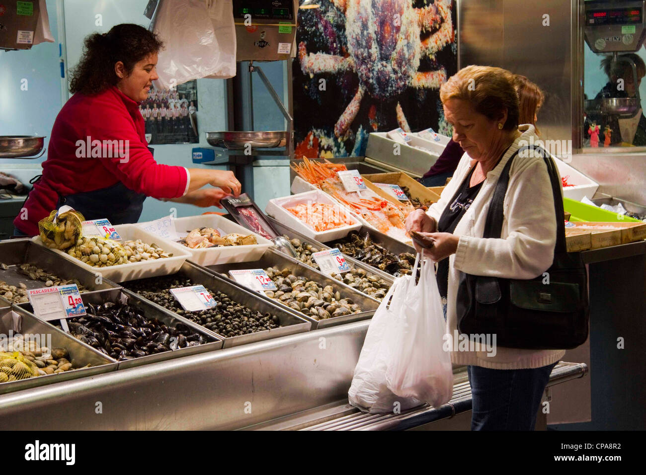 Buying fish at the Mercado de la Ribera market Bilbao Basque country ...