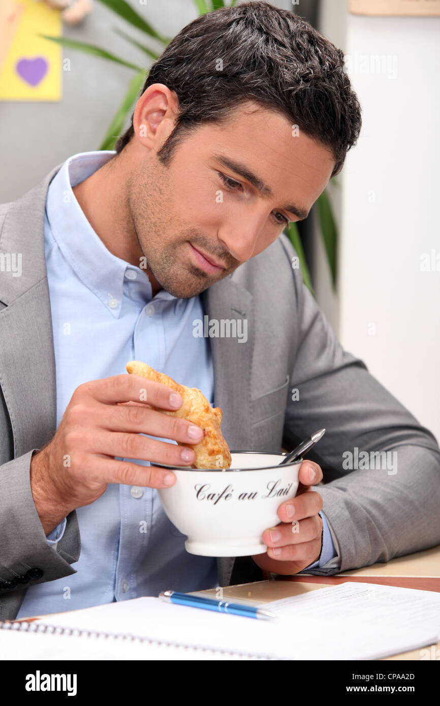 Young man having breakfast Stock Photo - Alamy