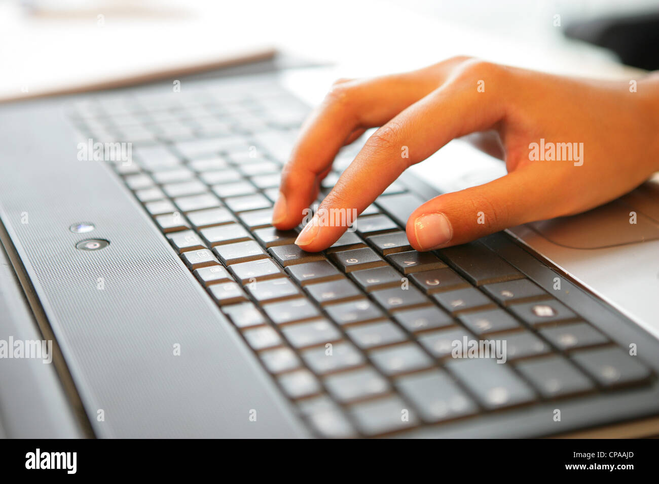 Hand placed on laptop keyboard Stock Photo - Alamy