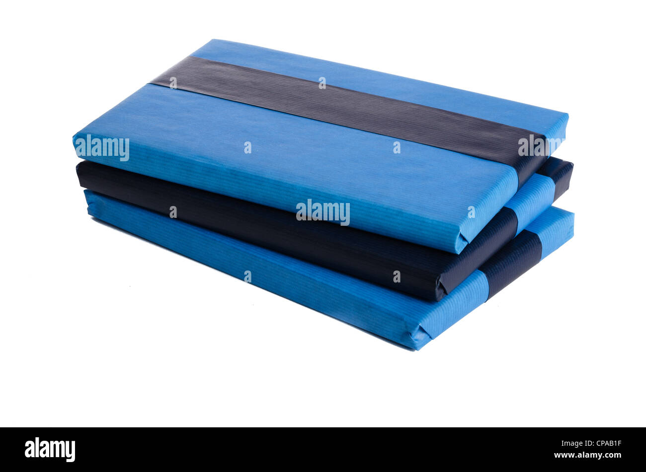 Three books in blue wrapping paper on white background Stock Photo - Alamy