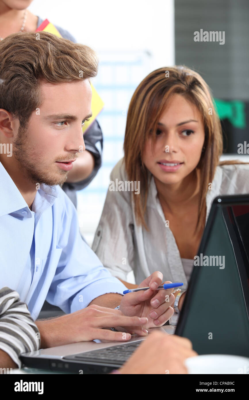 Couple of students in classroom Stock Photo - Alamy