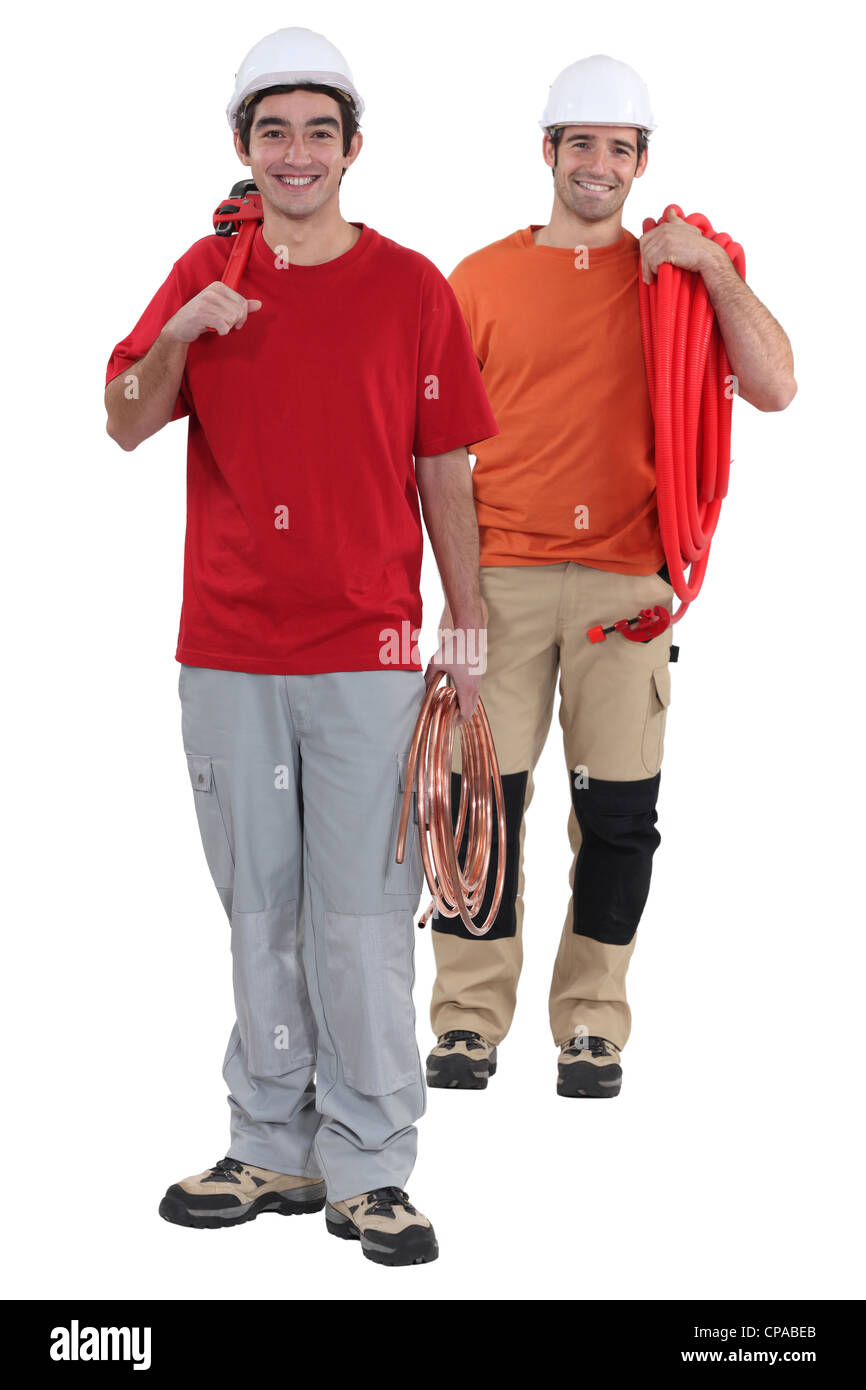Two plumbers with modern and traditional materials Stock Photo - Alamy