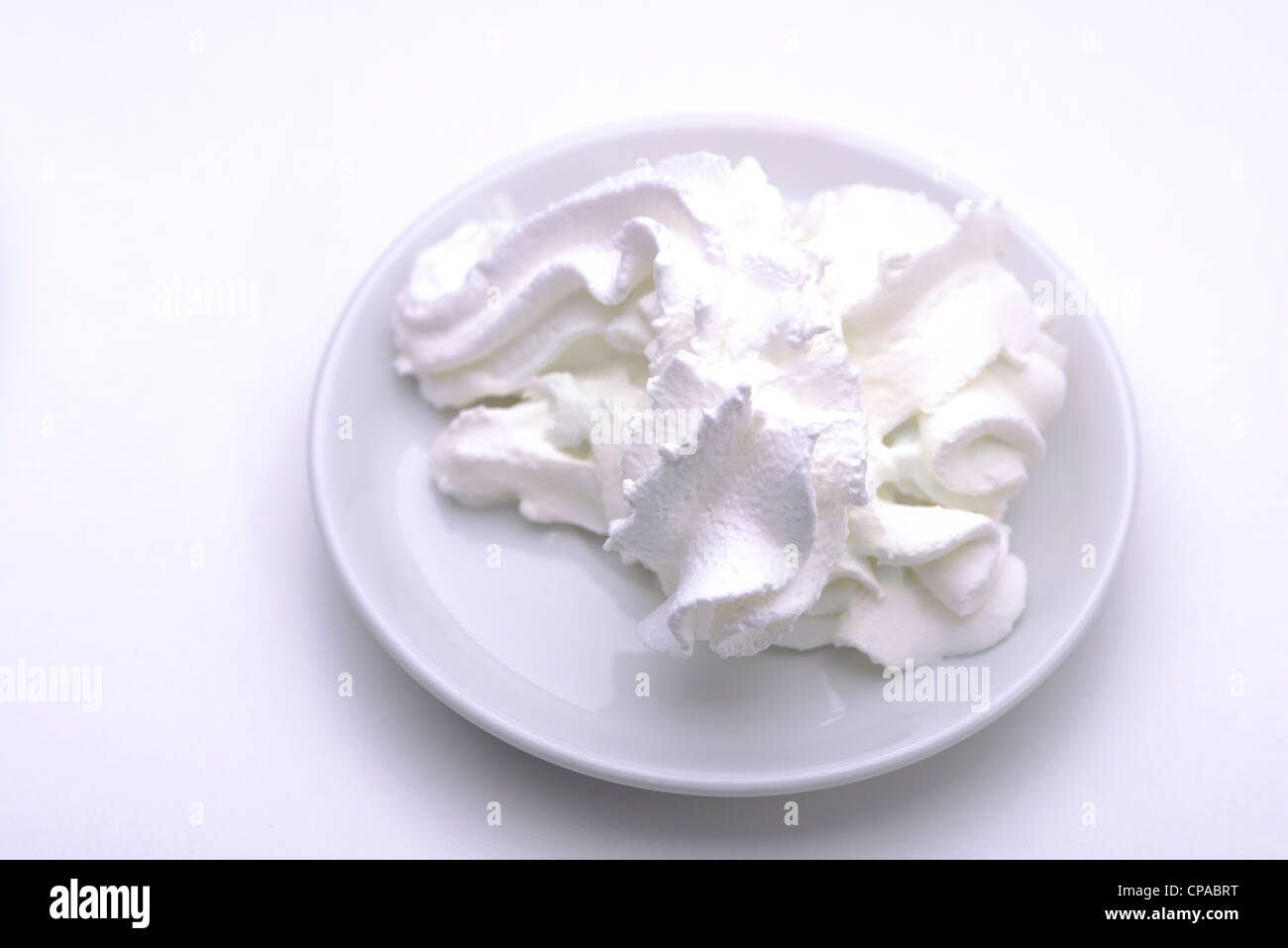 a plate with whipped cream Stock Photo - Alamy