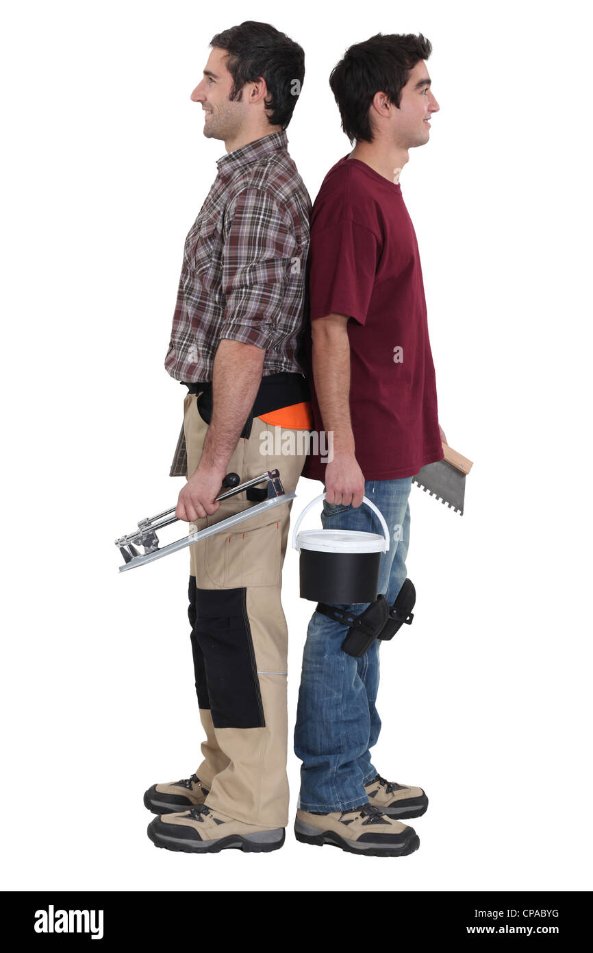 craftsman and apprentice standing back to back Stock Photo - Alamy