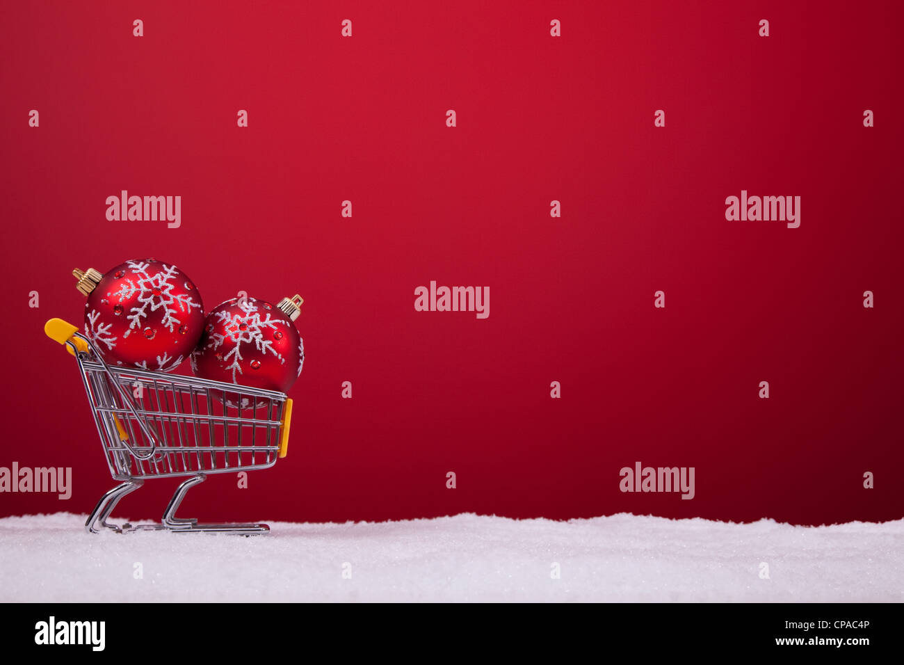 christmas balls in a shopping cart over a red background Stock Photo ...