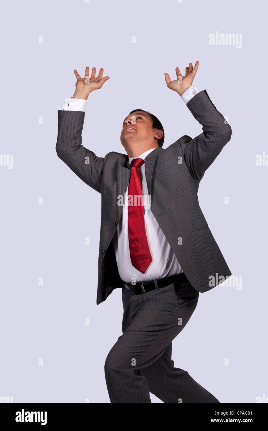 mature businessman scared with his arms up (above view isolated on gray ...