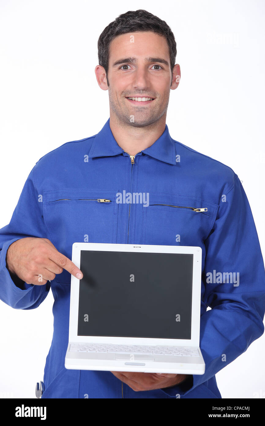 Manual worker pointing to laptop Stock Photo - Alamy