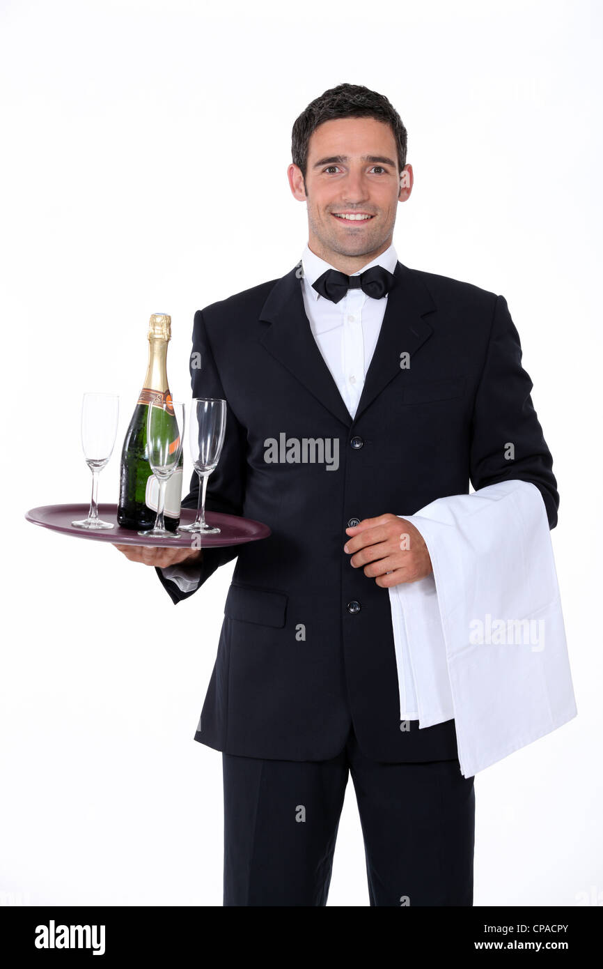Smart waiter holding tray of champagne glasses Stock Photo - Alamy