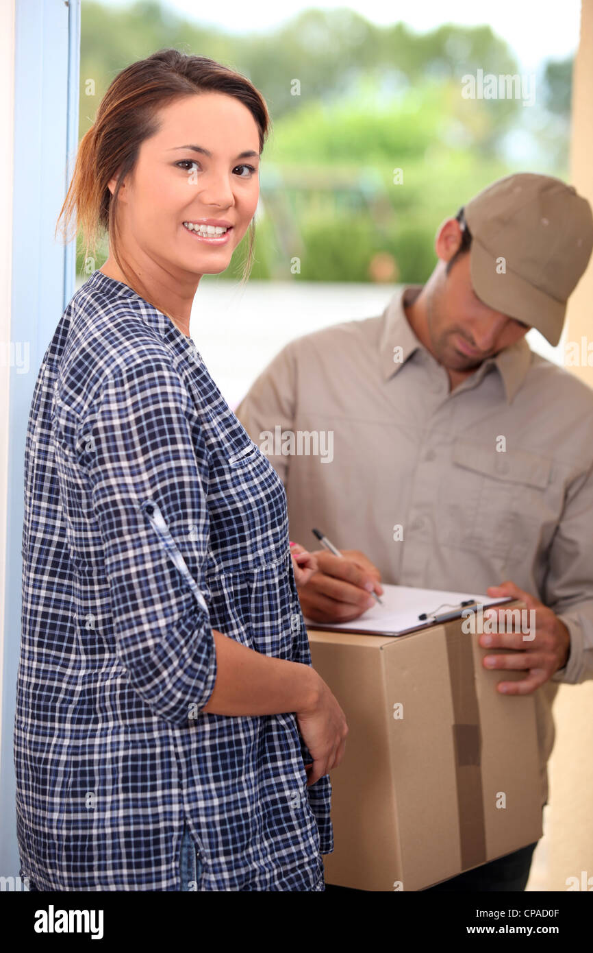 Woman receiving package Stock Photo - Alamy