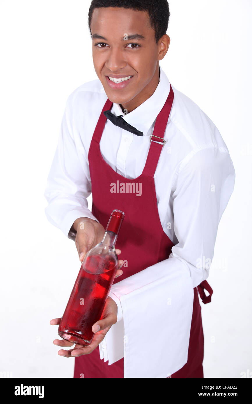 Waiter presenting bottle of wine Stock Photo - Alamy